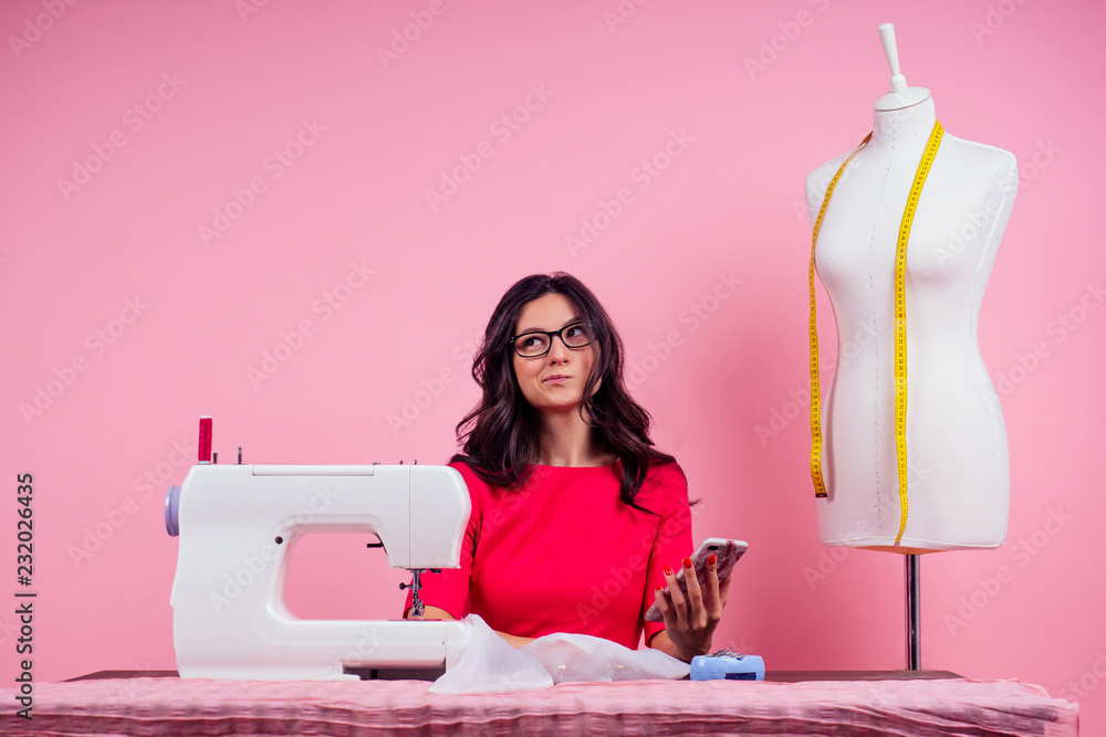 sewing pattern,sewing machine and maniken in studio pink background ...