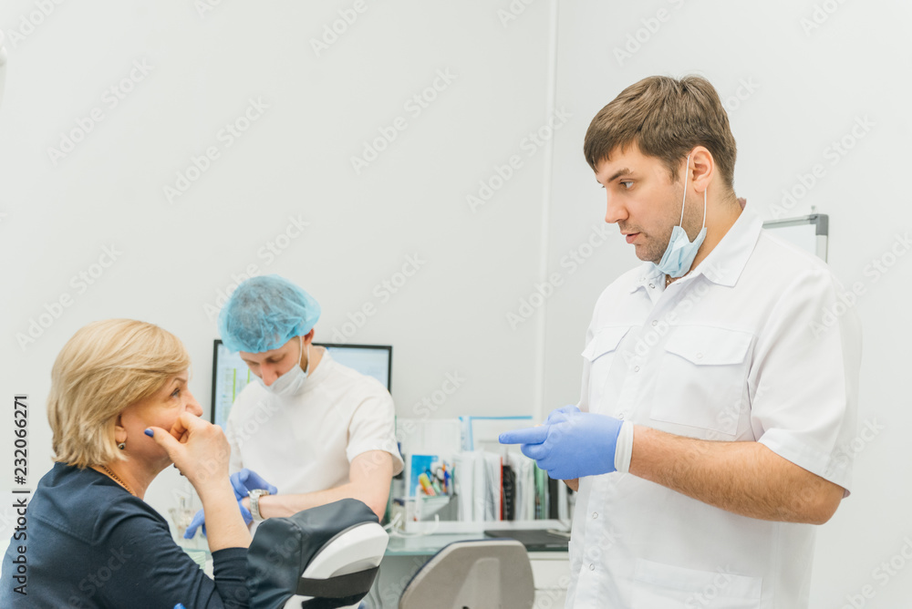 Doctor used microscope. Dentist is treating patient in modern dental ...