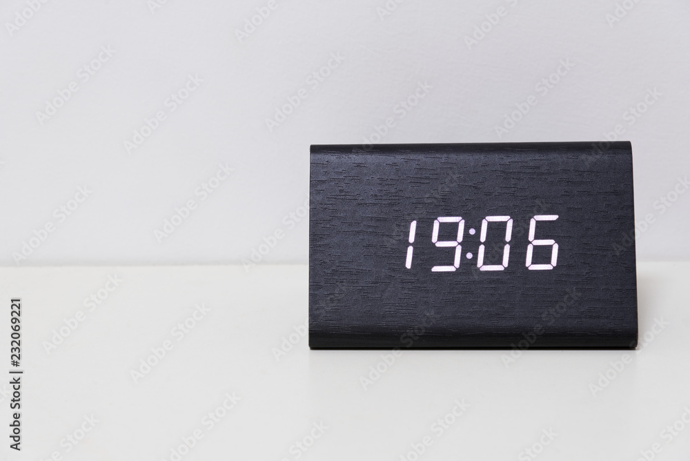 Black digital clock on a white background showing time 19:06 Stock ...