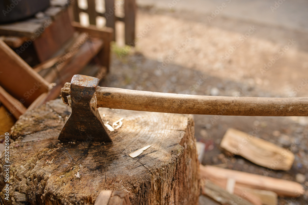 The ax is stabbed with a blade into the stump. Ax with wooden handle ...