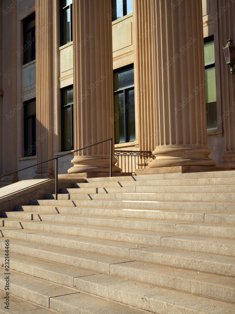 Side view of a railing and staircase leading up to a courthouse Stock ...