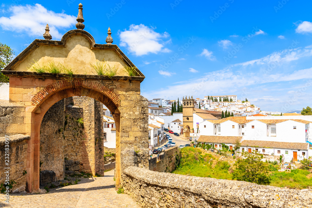 Castle gate and white houses in Ronda village in spring, Andalusia ...