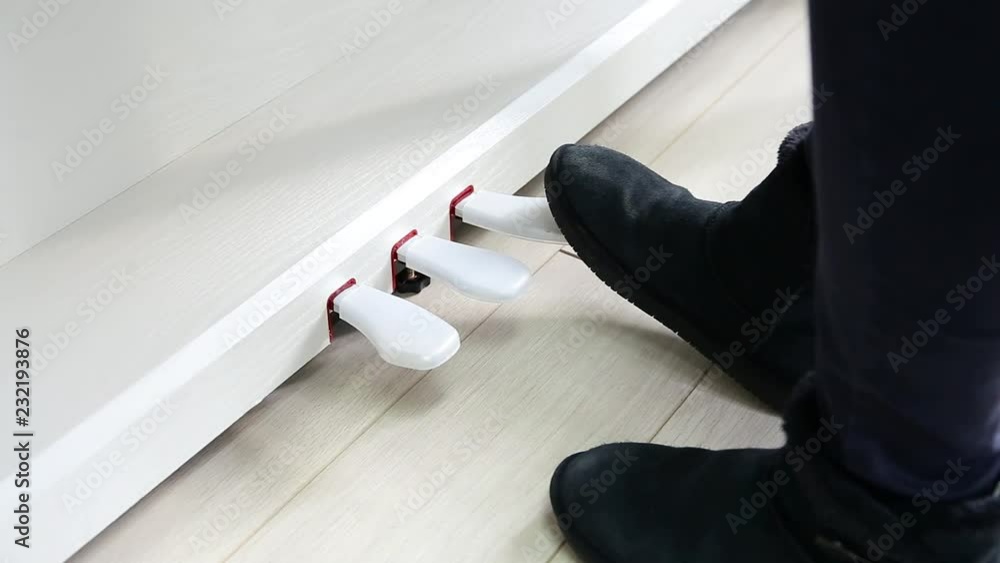 Close up scene of young girl pianist foot presing pedal on white piano ...