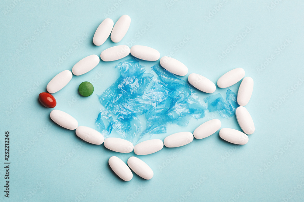 fish made of medicine pills, antibiotics and pieces of blue plastic ...