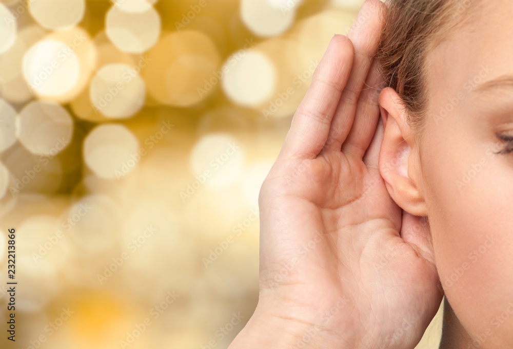 Girl listening with her hand on an ear cose up Stock Photo | Adobe Stock
