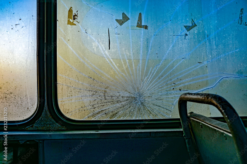 cracked wet glass in an old tram railway car, decommissioned car ...