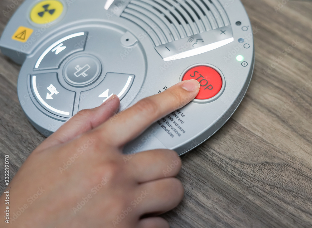 Female hand pressing stop sign button on CT scan control panel, Medical ...