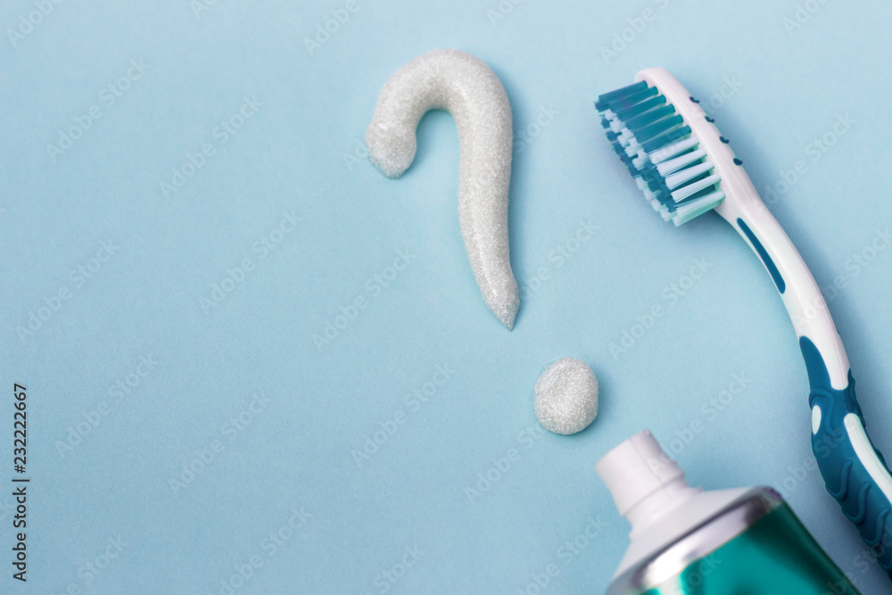 Question mark from toothpaste and toothbrush on blue background ...