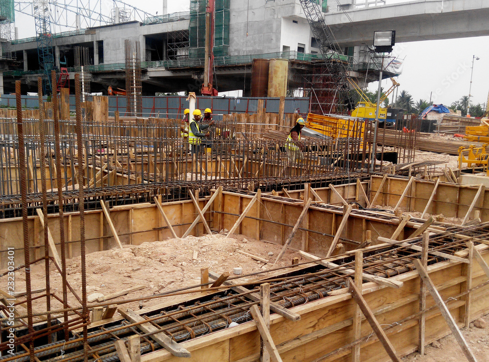 Ground beam form work constructed by workers at the construction site ...