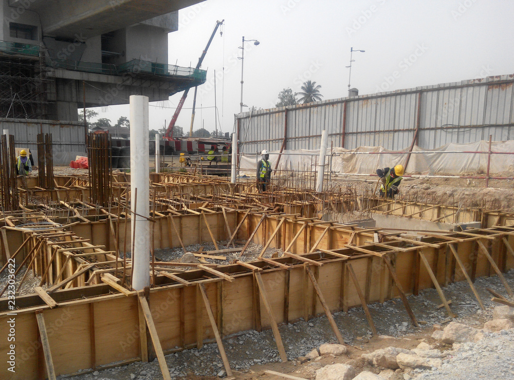 Ground beam form work constructed by workers at the construction site ...