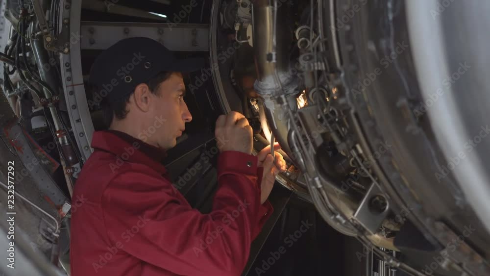 Engine passenger aircraft maintenance. Engineer checks the engine of ...