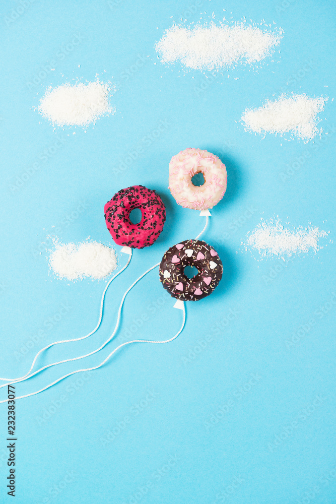 Mini donuts on blue background, creative food minimalism, donut in a ...