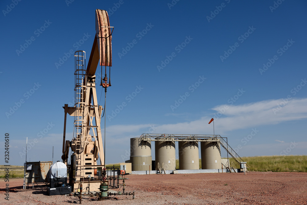 Pump jack and crude oil production storage tanks, Powder River Basin, with copy space. Stock ...
