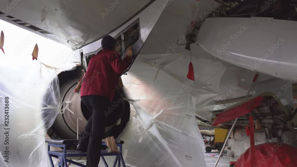 The engineer repairing the aircraft at the factory. Repair of an ...