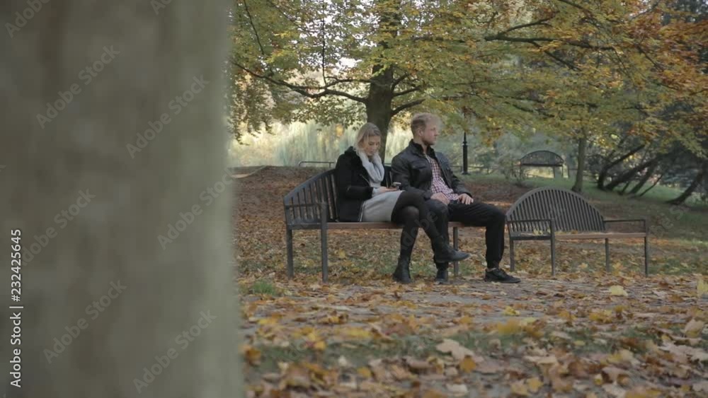 Vidéo Stock Voyeur gets caught spying on a young couple at the park from behind a tree | Adobe Stock