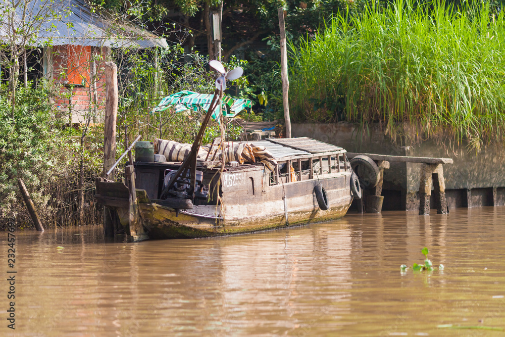 Traditional wooden vietnamese boat with added motor on the river at ...
