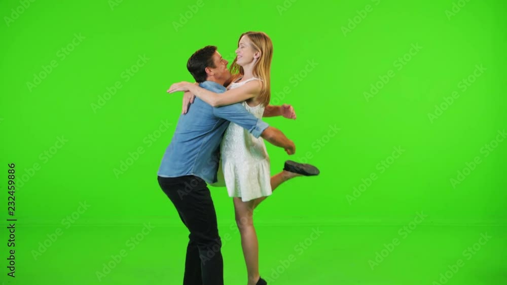 A in love man and a woman running to each other, hugging and spinning ...