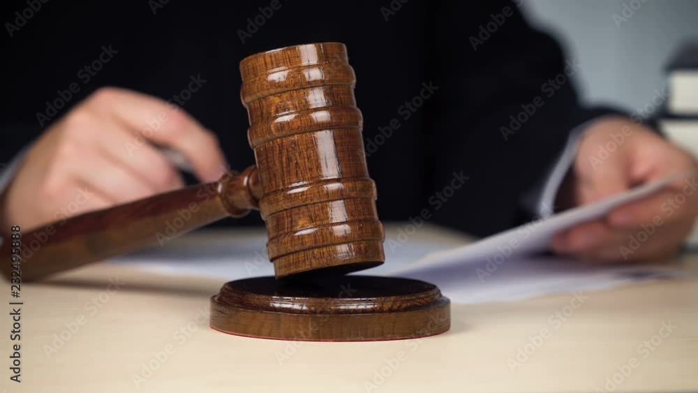 Judge reading decision and hitting gavel to close the proceeding, law ...