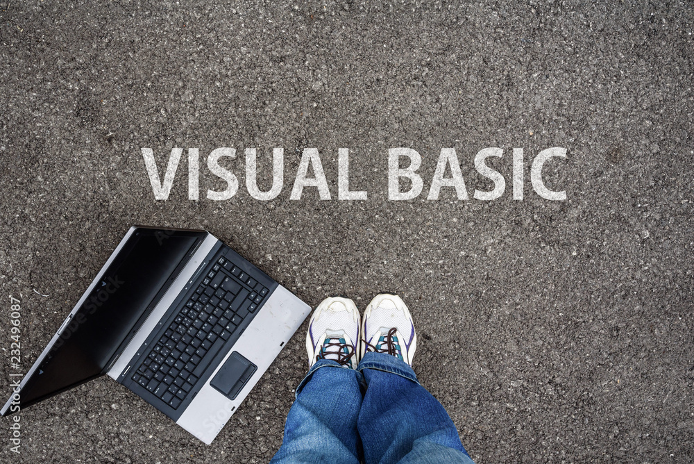 man legs in sneakers standing next to laptop and words Visual Basic ...