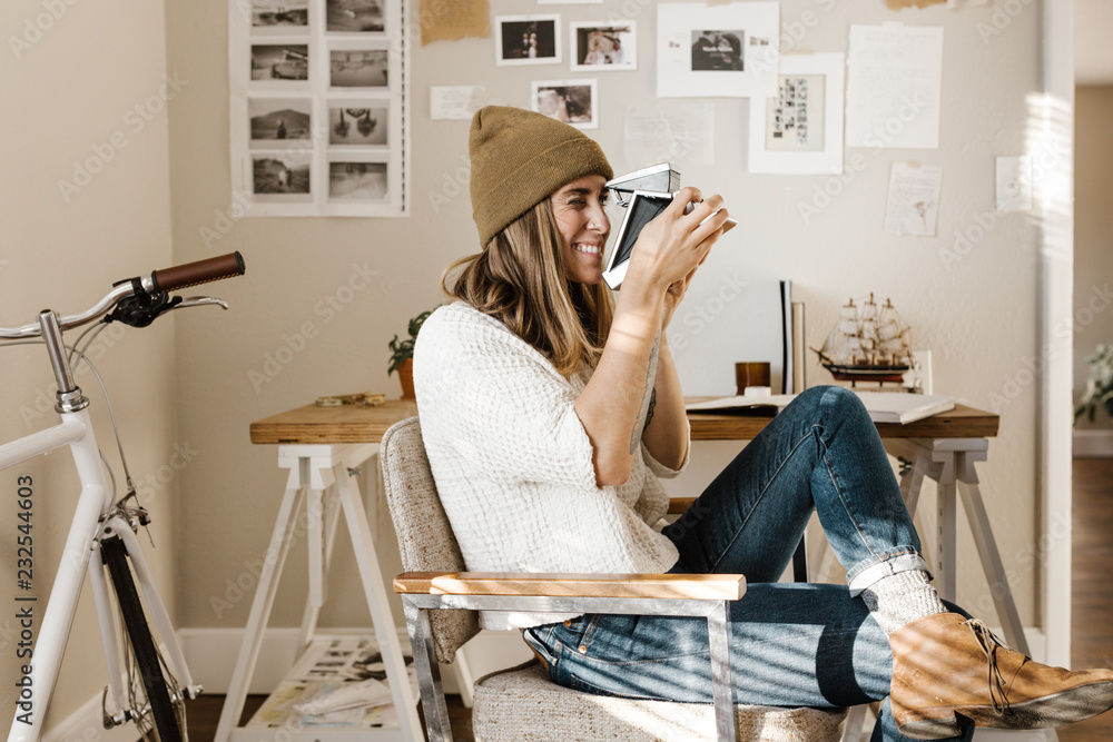 photographer in home studio with instant camera Stock Photo | Adobe Stock