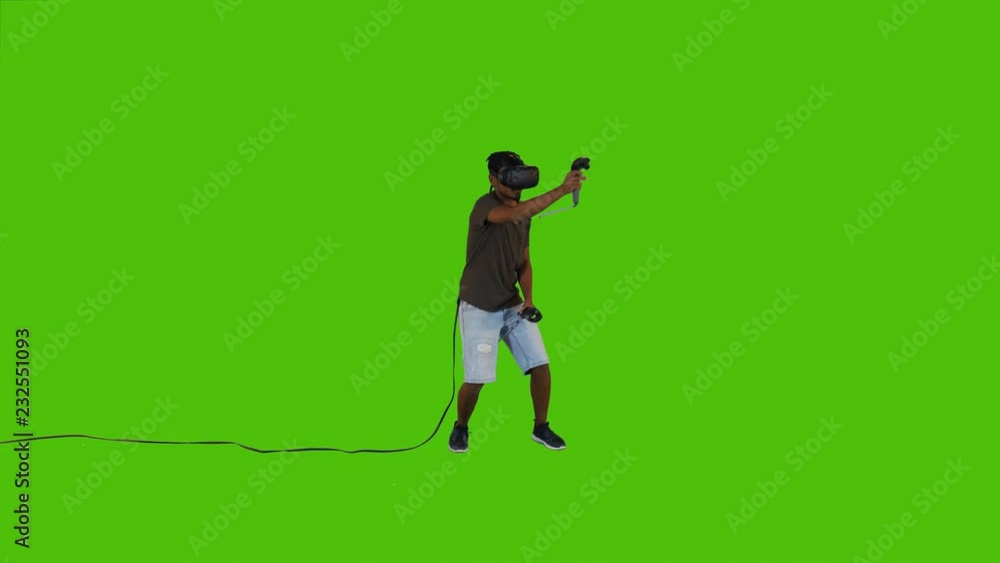 First person shooting with guns in a VR video game by a young man over ...