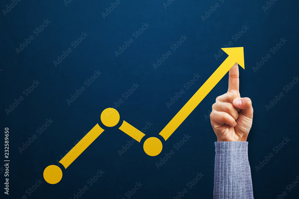 Businessman is touching arrows pointing up with graph as a symbol of ...