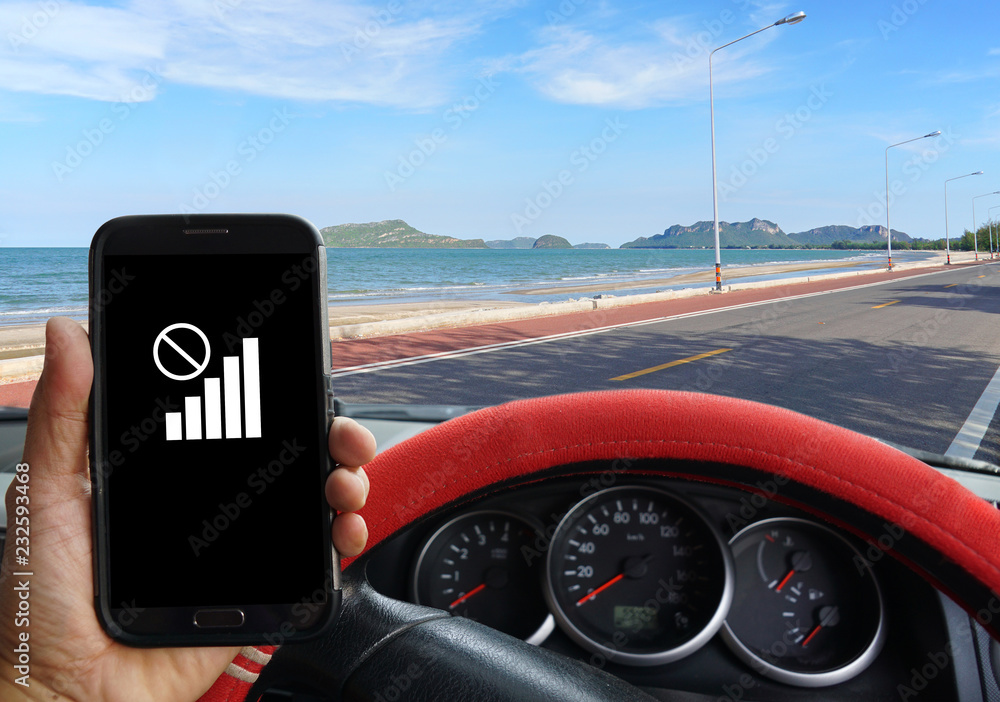 Man parking the car to use smartphone which showing No signal icon ...