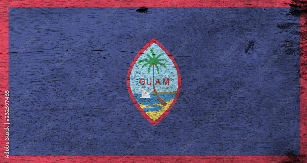 Flag of Guam on wooden plate background. Grunge Guam flag texture, dark ...