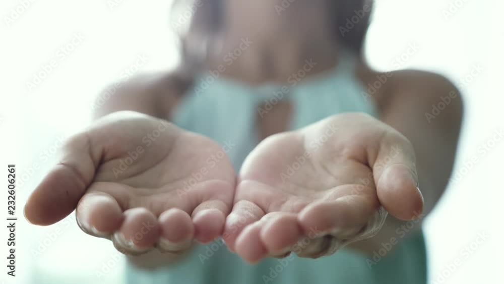 Putting female hands together and showing them towards camera on a ...