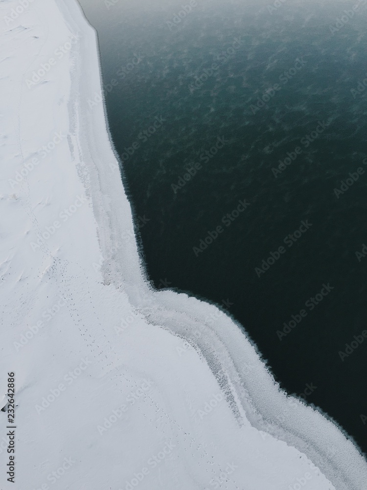 Line of frozen ice on water Stock Photo | Adobe Stock