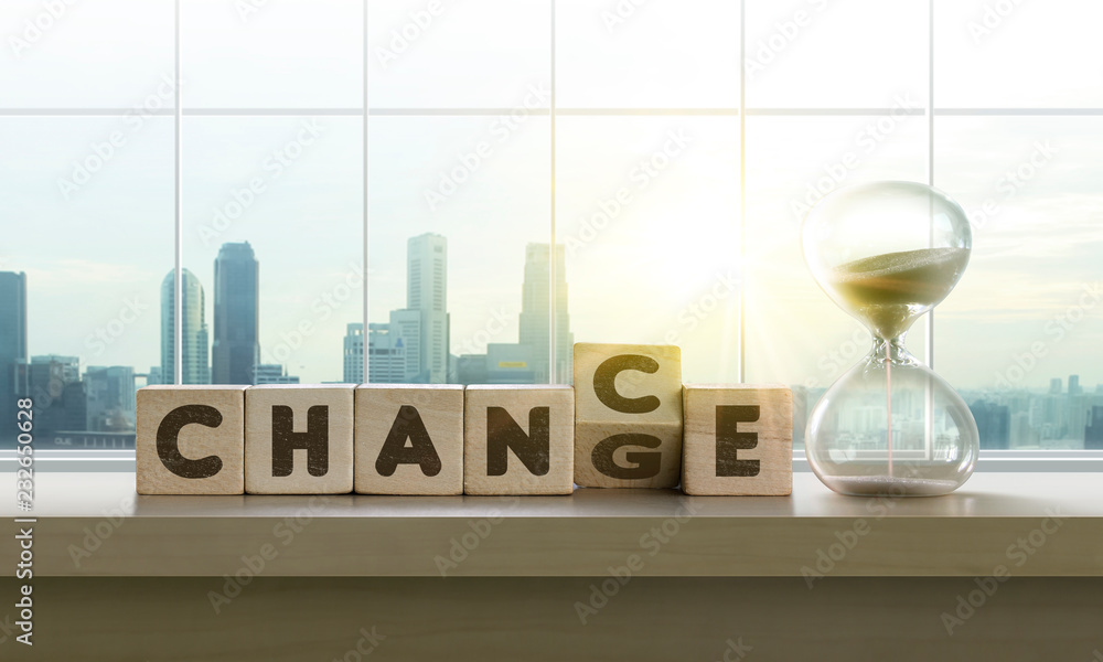 Wooden blocks with the word Change-Chance and sand clock on table with ...