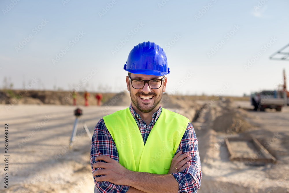 Engineer with crossed arms on building site Stock Photo | Adobe Stock