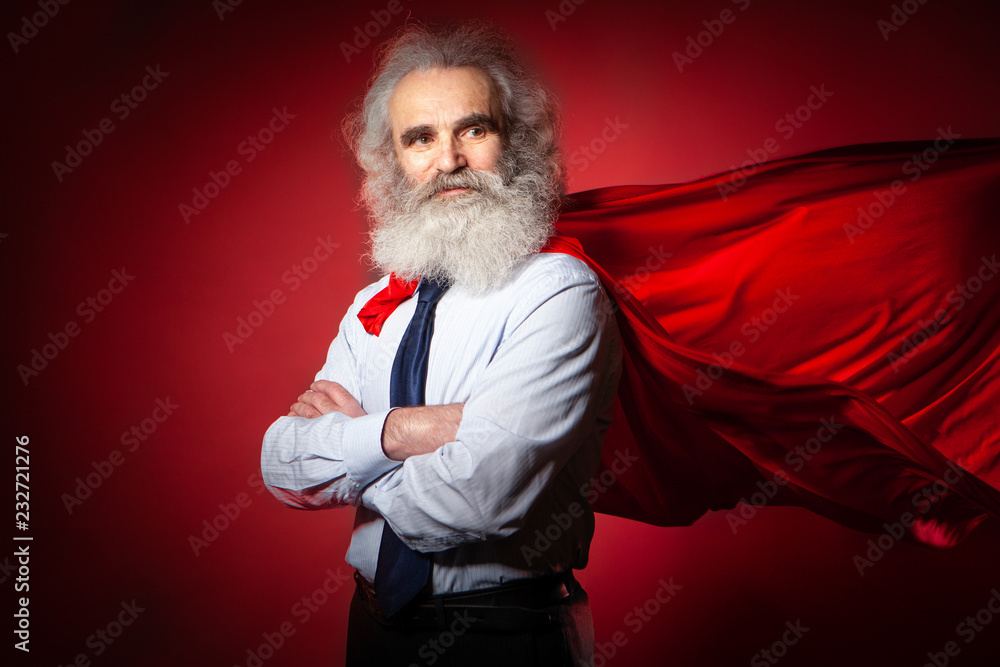 Grandpa is a superhero. Elderly man with a red cape. A man with a beard ...