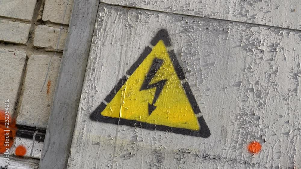 Sign of danger of electric shock rotates close-up rotate. Yellow ...