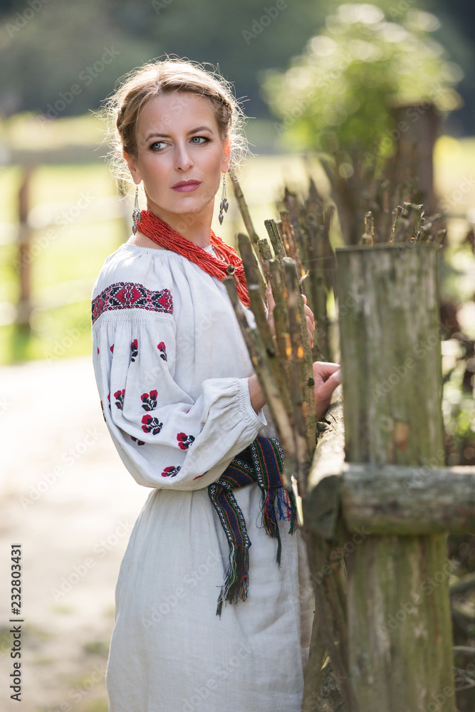 Ukrainian girl in embroidered dress in the village. Portrait of ...
