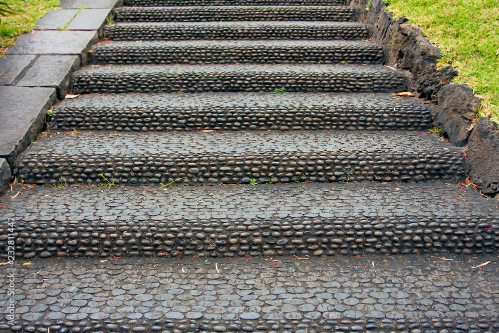 Staircase with steps of round small pebbles. Modern stone staircase ...