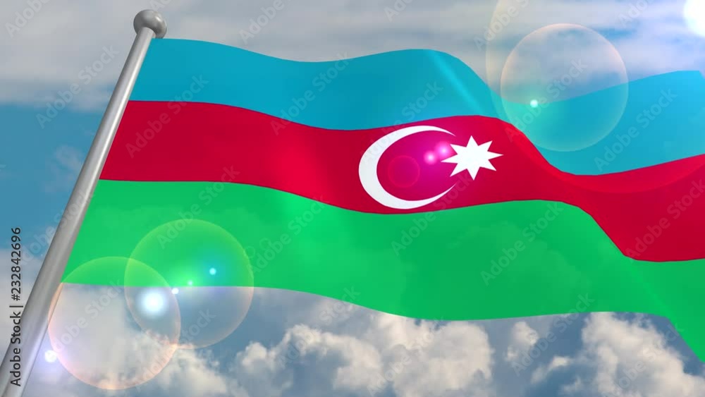 The flag of the state of Azerbaijan develops in the wind against a blue ...
