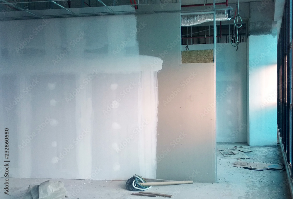 Drywall installation work in progress by construction workers at the ...