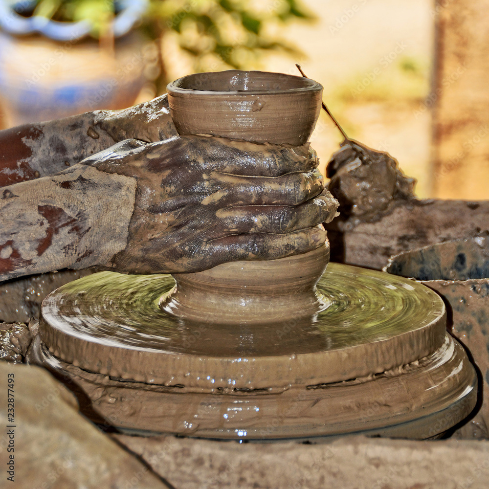 Potter busy making a pot. Potter works with clay by hands. Handmade ...