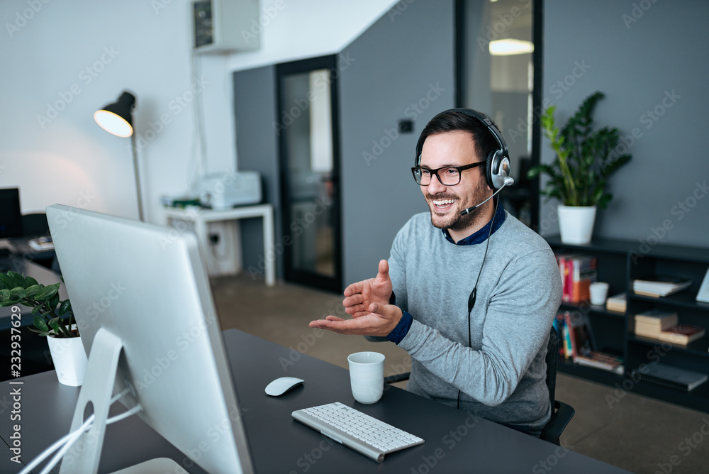 Handsome young man having online call at modern office. Stock Photo ...