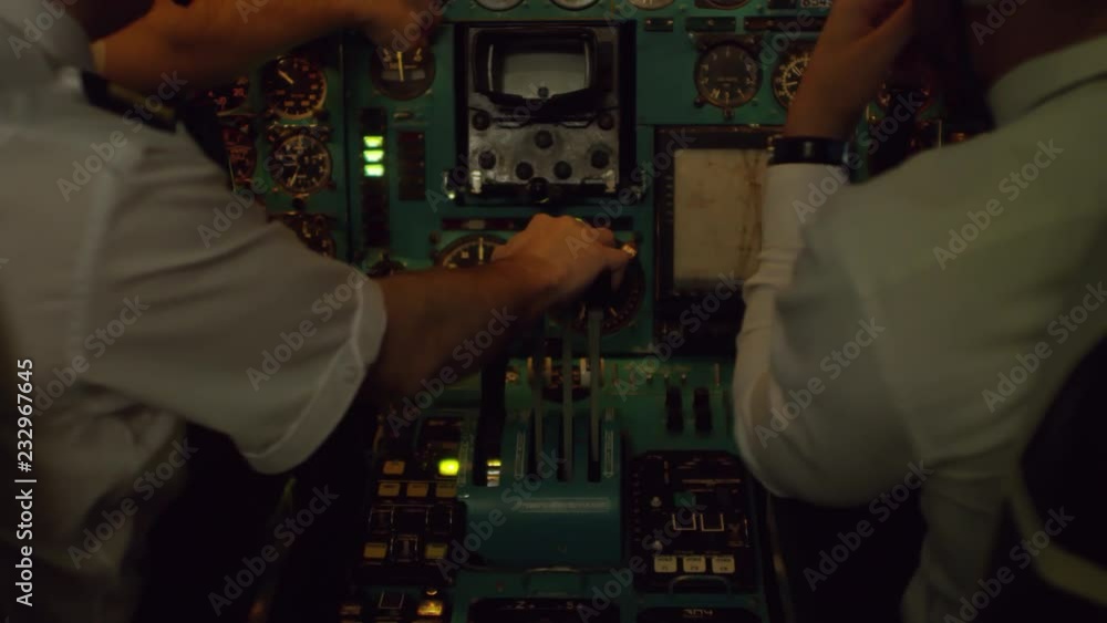 Mid-section shot of unrecognizable aircraft captain operating throttle ...