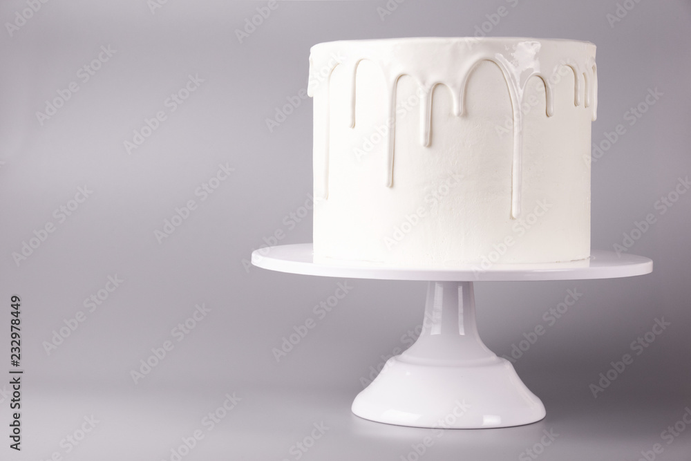 Simple white cake with glaze on a gray background. Stock Photo | Adobe ...