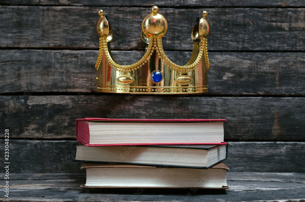 Premium books under a king crown. VIP high quality education concept ...