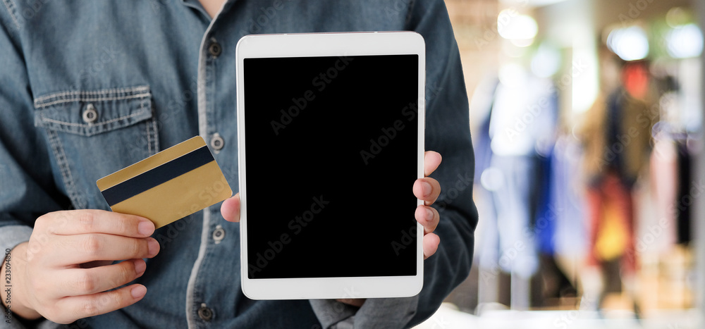Hand holding credit card and digital tablet with blank on screen for ...