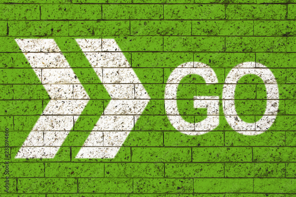 Go white word text and two large direction arrows on green stone brick ...
