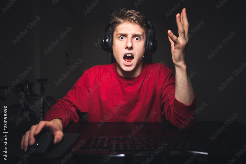 Young gamer is angry with the bad team play in the video game. Portrait ...