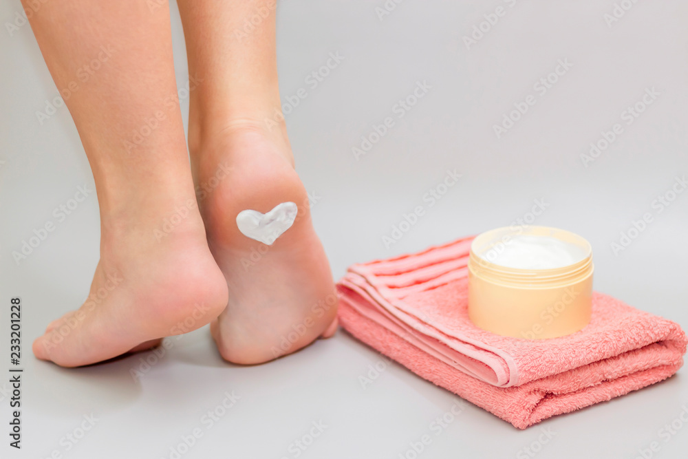 Beautiful female legs with heart from ointment cream on heel. Woman ...