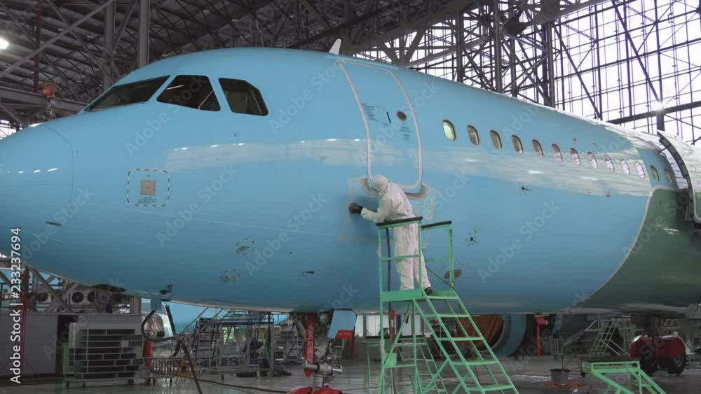 Painting the aircraft at the factory. The engineer repairing the ...