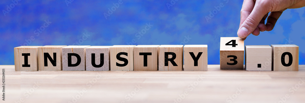 Hand is turning a dice and changes the word "Industry 3.0" to "Industry ...