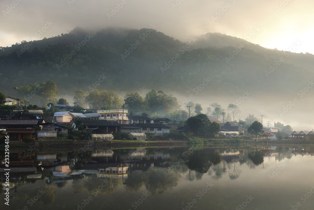 Beautiful scenery during sunrise with the mist and water reflection of ...